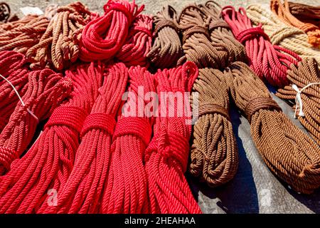 Close up shot of heap of braided hemp ropes made for sale at outdoor ...