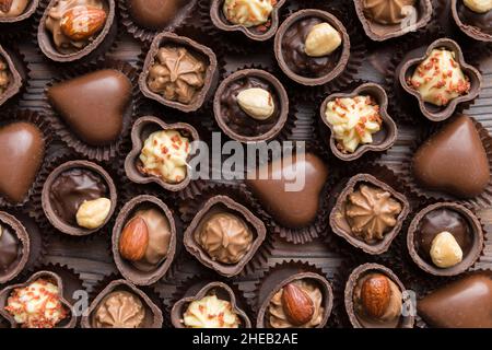 Different kinds of chocolates on colored table close-up. Top View and ...