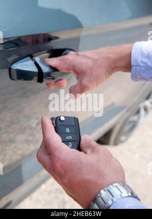 Car keyless entry remote in the owner hand on the car Stock Photo - Alamy