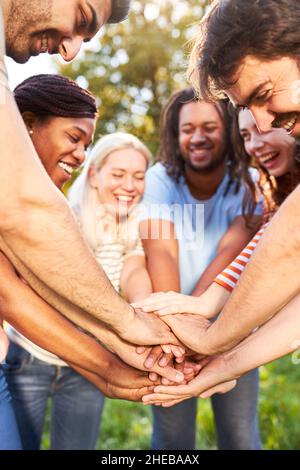 Friends stacking hands together Stock Photo - Alamy