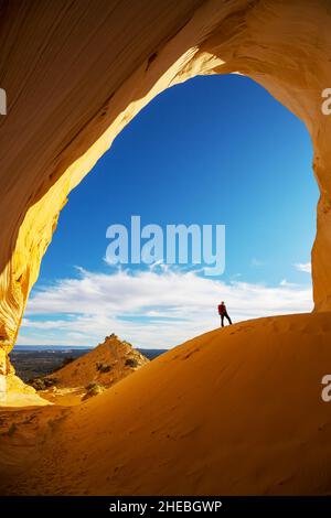 Hiker in the Great Chamber grotto, Utah, USA. Travel and journey scene ...