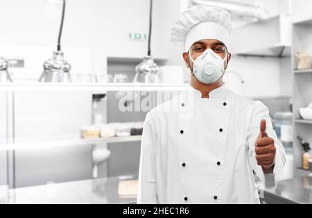 chef in respirator showing thumbs up at kitchen Stock Photo - Alamy