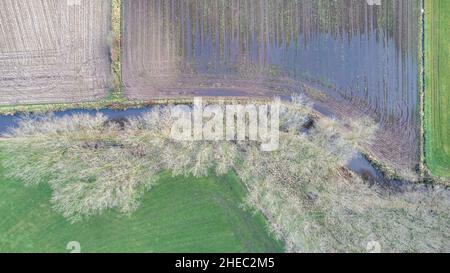 Aerial view of a flooded land plot with cars during the spring flood, a ...