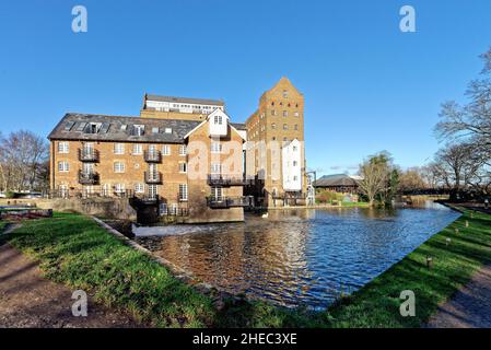 Coxes Lock Mill apartments on the River Wey Navigation canal on a sunny ...