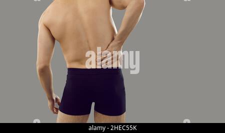 Back side of man suffering from backache isolated on white background ...