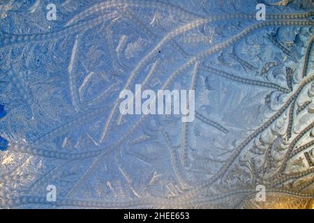 Window frost "ice flowers" form on an airplane window at high altitude ...