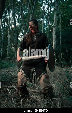 Mad furious viking woman warrior with a sword in her hands, in the ...