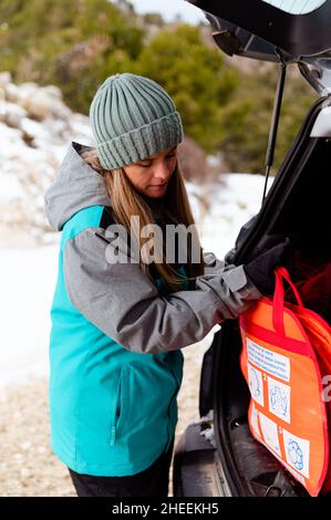 Woman with warm winter clothes taking a photo with her smartphone in ...