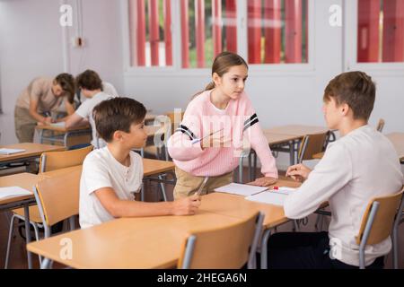Pupils performing group tasks in classroom Stock Photo - Alamy