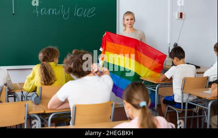 Teacher explaining meaning of LGBT flag to kids in school Stock Photo ...
