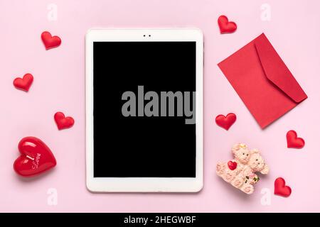digital tablet for chooses gifts, makes purchase, envelope, red hearts ...