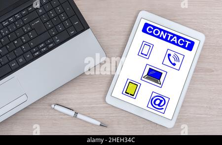 Contact concept shown on a tablet used by a woman Stock Photo - Alamy
