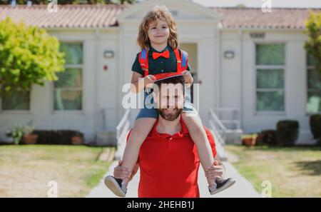 Father get a son pupil piggyback ride after study school. Family ...