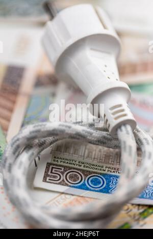 Electric cable with socket and many Polish banknotes. Rise of ...