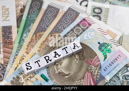 The wording "Strata" translated as "Loss" plus many Polish banknotes ...