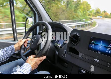 Man at the cockpit of a Mercedes Sprinter Stock Photo - Alamy
