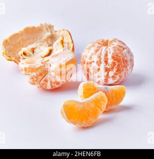 Two peeled tangerines isolated over white background Stock Photo - Alamy