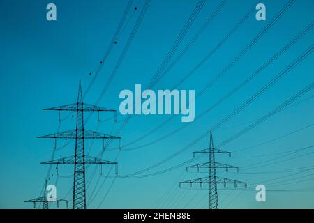 crossing electric pylon in sunset sky Stock Photo - Alamy