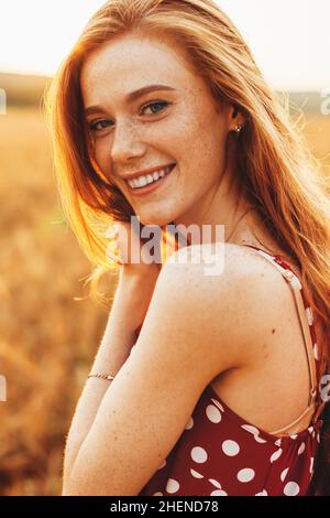 Friendly carefree pretty redhead woman talking on phone, having ...