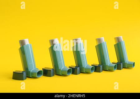 Asthma inhalers on yellow background Stock Photo - Alamy
