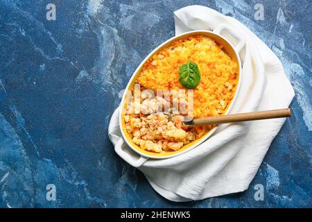 Baking dish with tasty English fish pie on blue background Stock Photo - Alamy