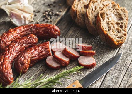 Traditional smoked meat on wooden table. Organic products on a wooden ...