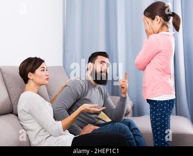 Young father and mother correcting their child for disobedience Stock ...