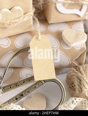 Valentines kraft paper wrapped present with vertical gift tag and ...