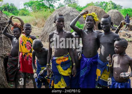 Mursi People Children in National Costumes in the Tribe Village Stock ...