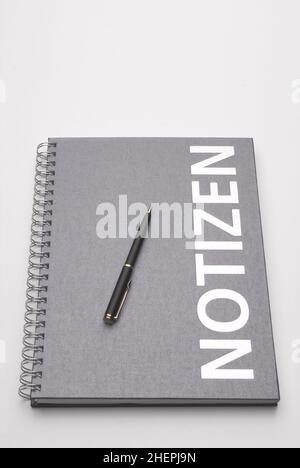 Note-book with a biro Stock Photo - Alamy