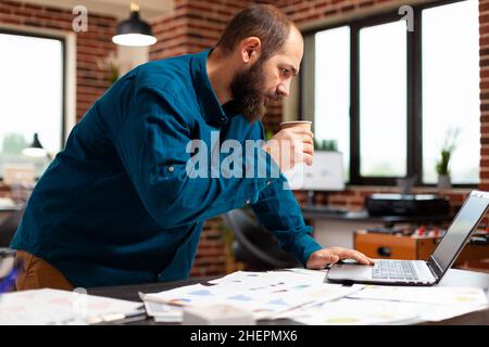 Businessman analysing marketing graphs at office; light effect Stock ...