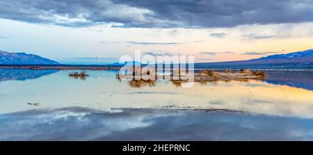 scenic lake near death valley with dark clouds in the national park ...