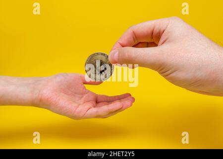 Golden bitcoin in a child's hand close up, isolate Stock Photo - Alamy