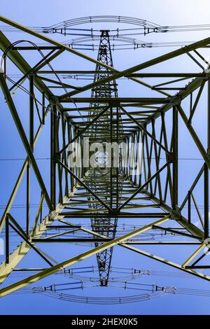 electric pylon under blue sky as industry background Stock Photo - Alamy