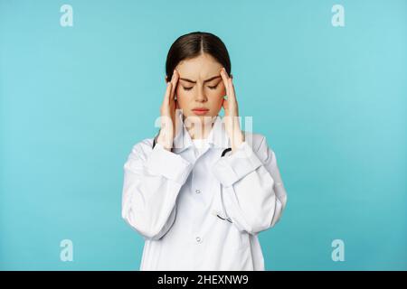 Image of woman doctor, medical personel grimacing from discomfort ...