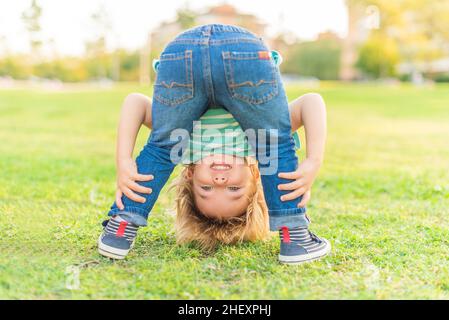 Toddler looking through legs Stock Photo - Alamy