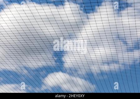 metal net with blue sky gives a harmonic background Stock Photo - Alamy