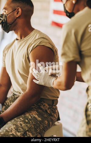 Military woman receiving vaccine injection in military hospital Stock ...