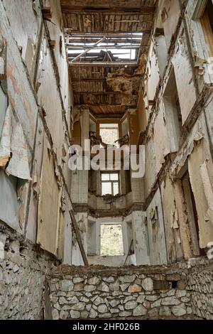 The interior of an abandoned crumbling building. A dying city ...