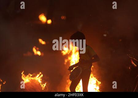People light a bonfire to celebrate Bhogi, a traditional Hindu festival ...