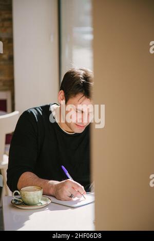 Business man writing something the paper Stock Photo - Alamy