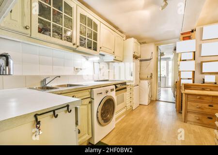 Nice kitchen in light colors with a washing machine built into the ...