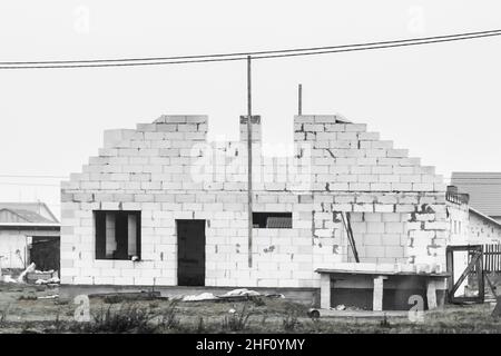 Unfinished construction in rural area. Unfinished building outdoor ...