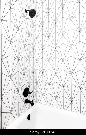 A kavala tiled shower with a black faucet and hardware and a large ...