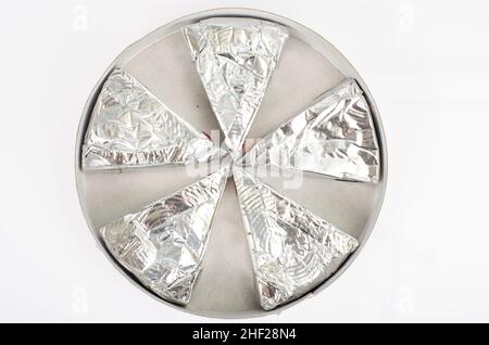 Cheese triangles in foil. Studio Photo Stock Photo - Alamy