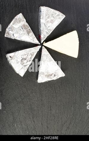 Cheese triangles in foil. Studio Photo Stock Photo - Alamy