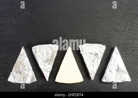 Cheese triangles in foil. Studio Photo Stock Photo - Alamy