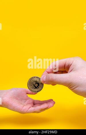 Golden bitcoin in a child's hand close up, isolate Stock Photo - Alamy