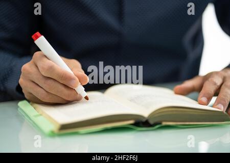 Man Hand With Highlighter Reading Book Stock Photo - Alamy