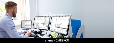 Portrait of software engineer writing code arranging glasses and being ...